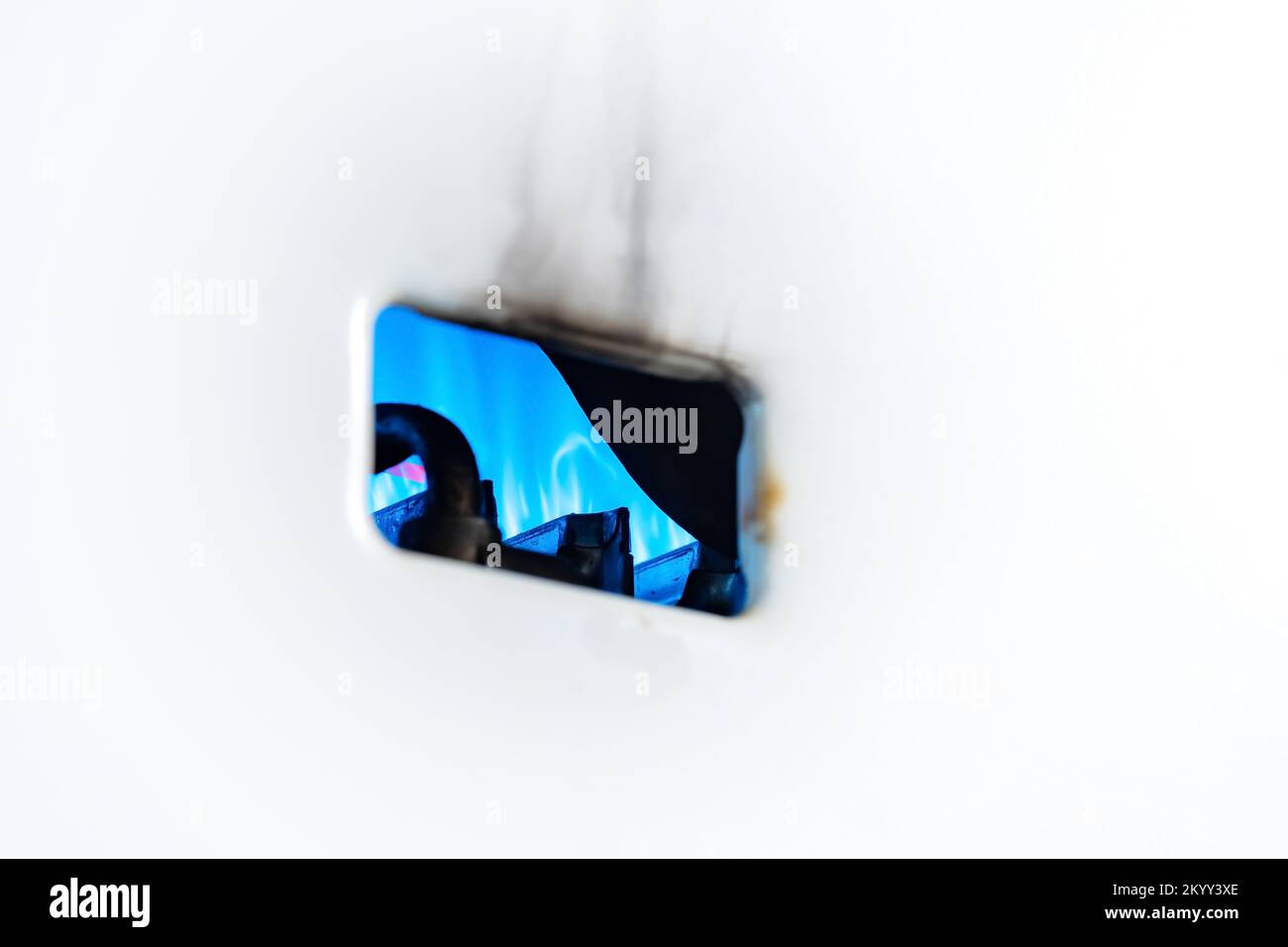 Gas water heater in the bathroom or kitchen, blue gas flame burning ...