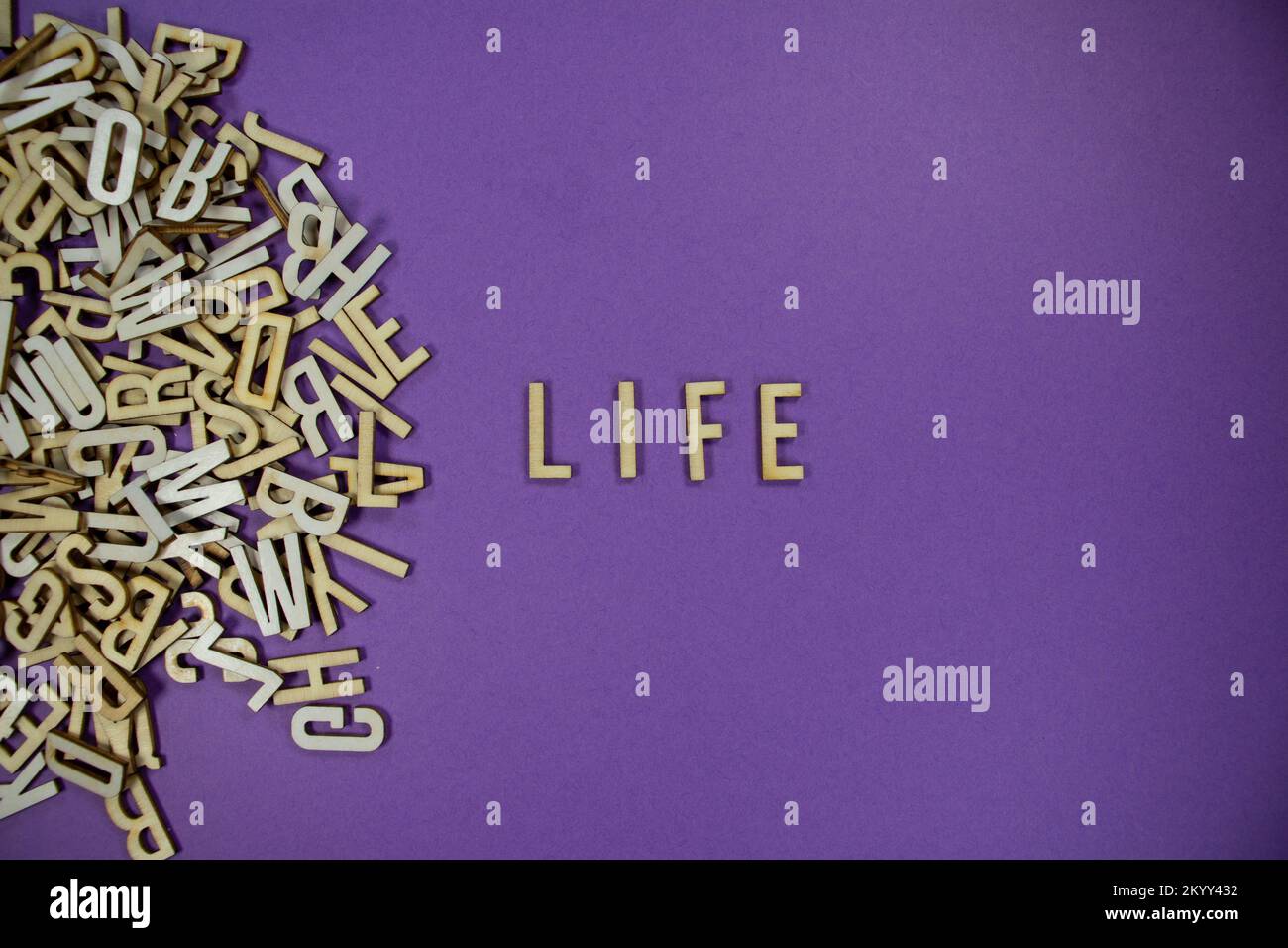 pile of wooden English language capital letters spilling into words ...