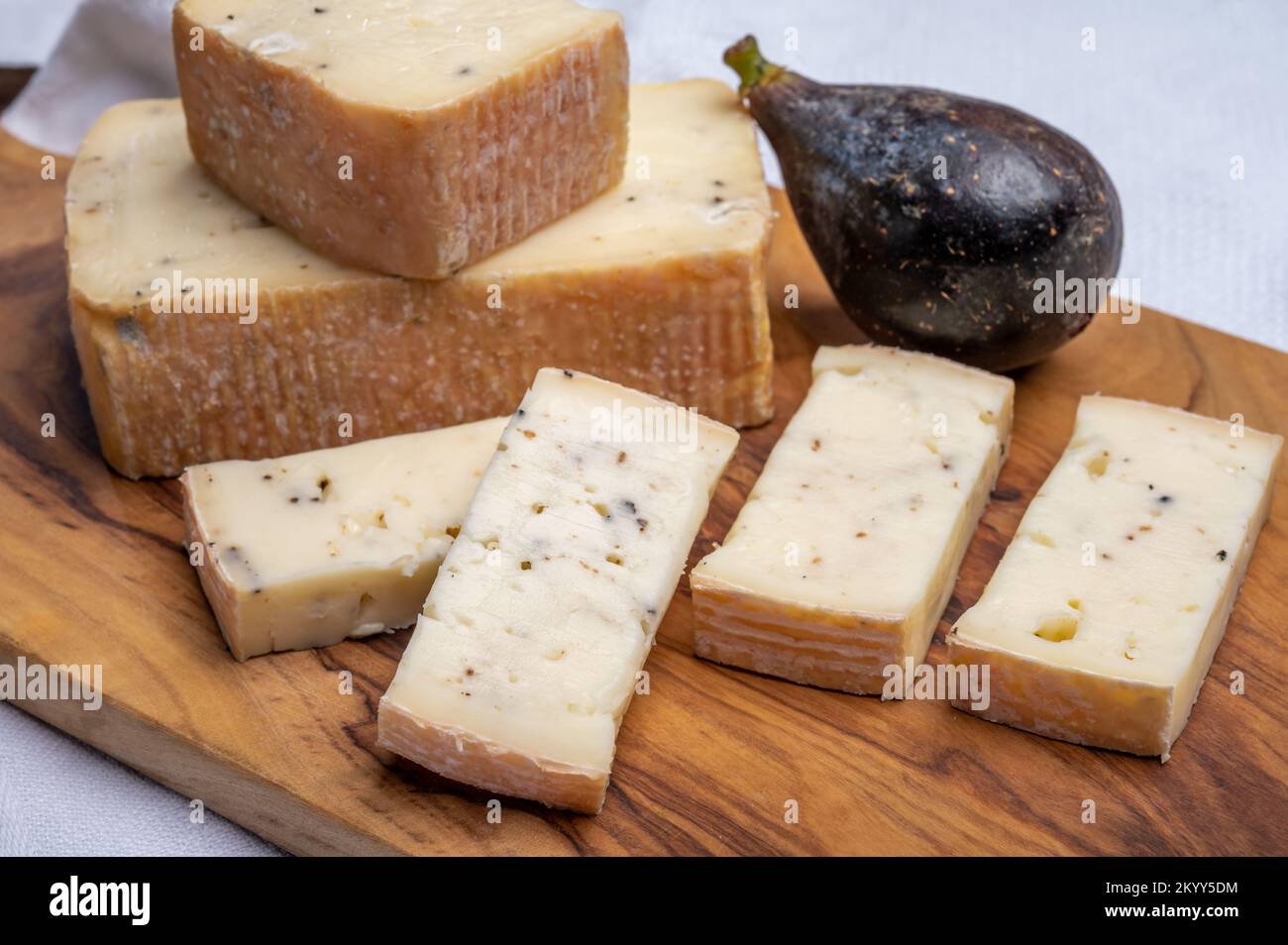 Italian cheese collection, yellow taleggio cheese with black truffles ...