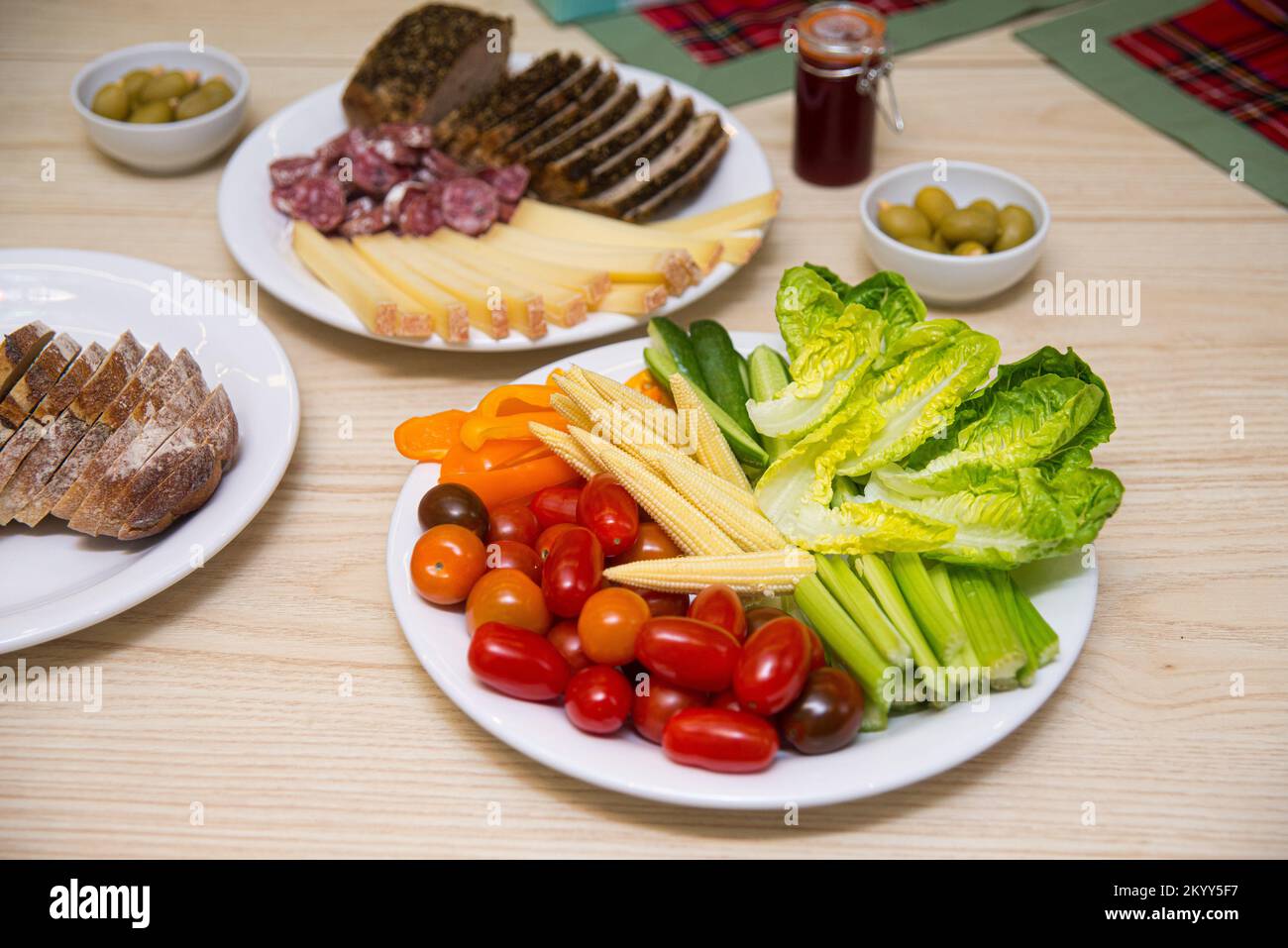 Plate of cold snacks and appetizers like fresh baby plum tomatoes, mini ...