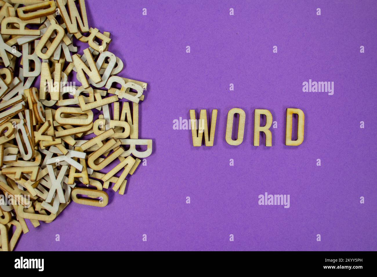 purple background with a pile of wooden capital letters spilling into ...