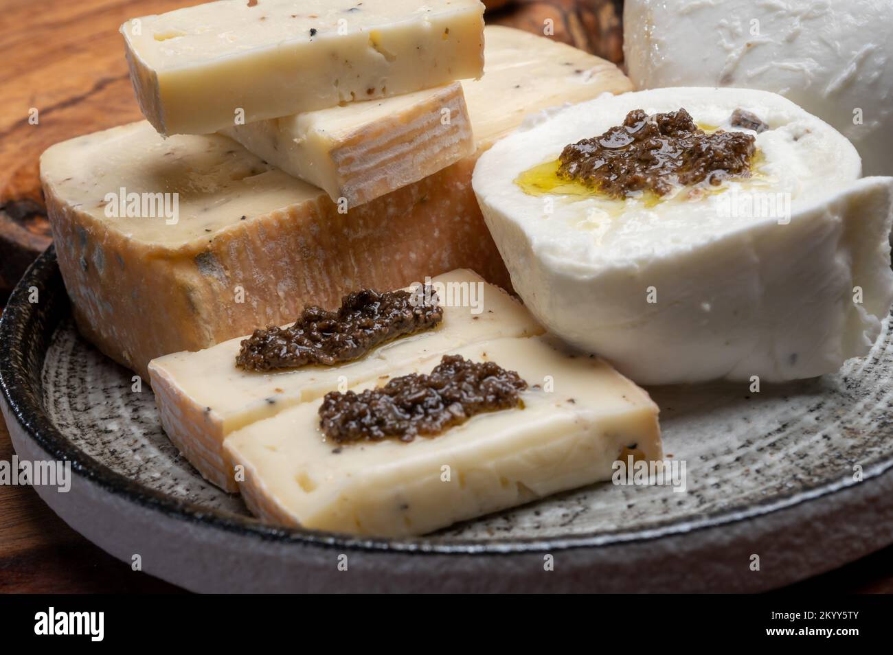 Italian cheese collection, yellow taleggio cheese and white mozzarella ...