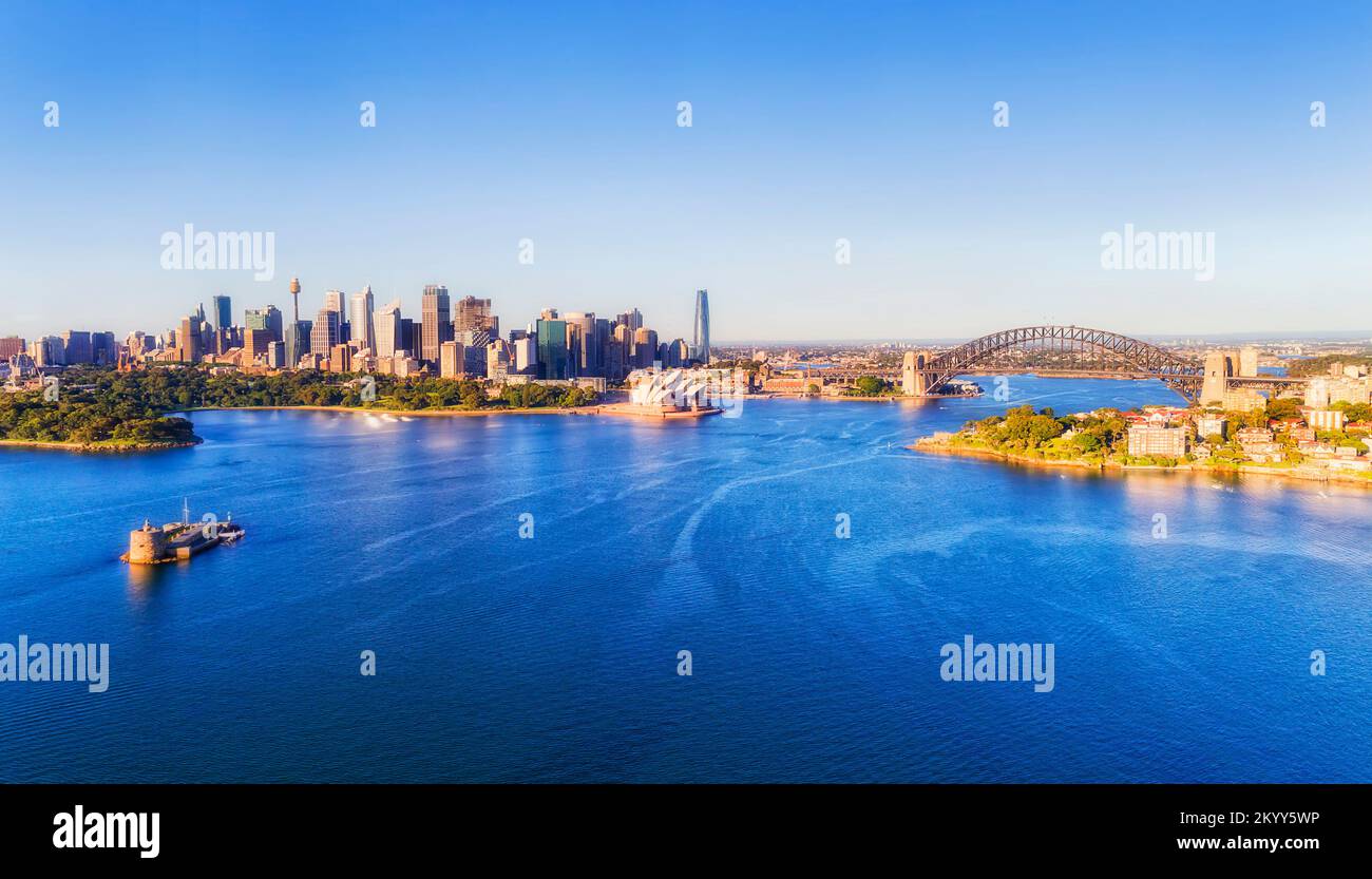 Wide aerial cityscape over blue waters of Sydney harbour at City of ...