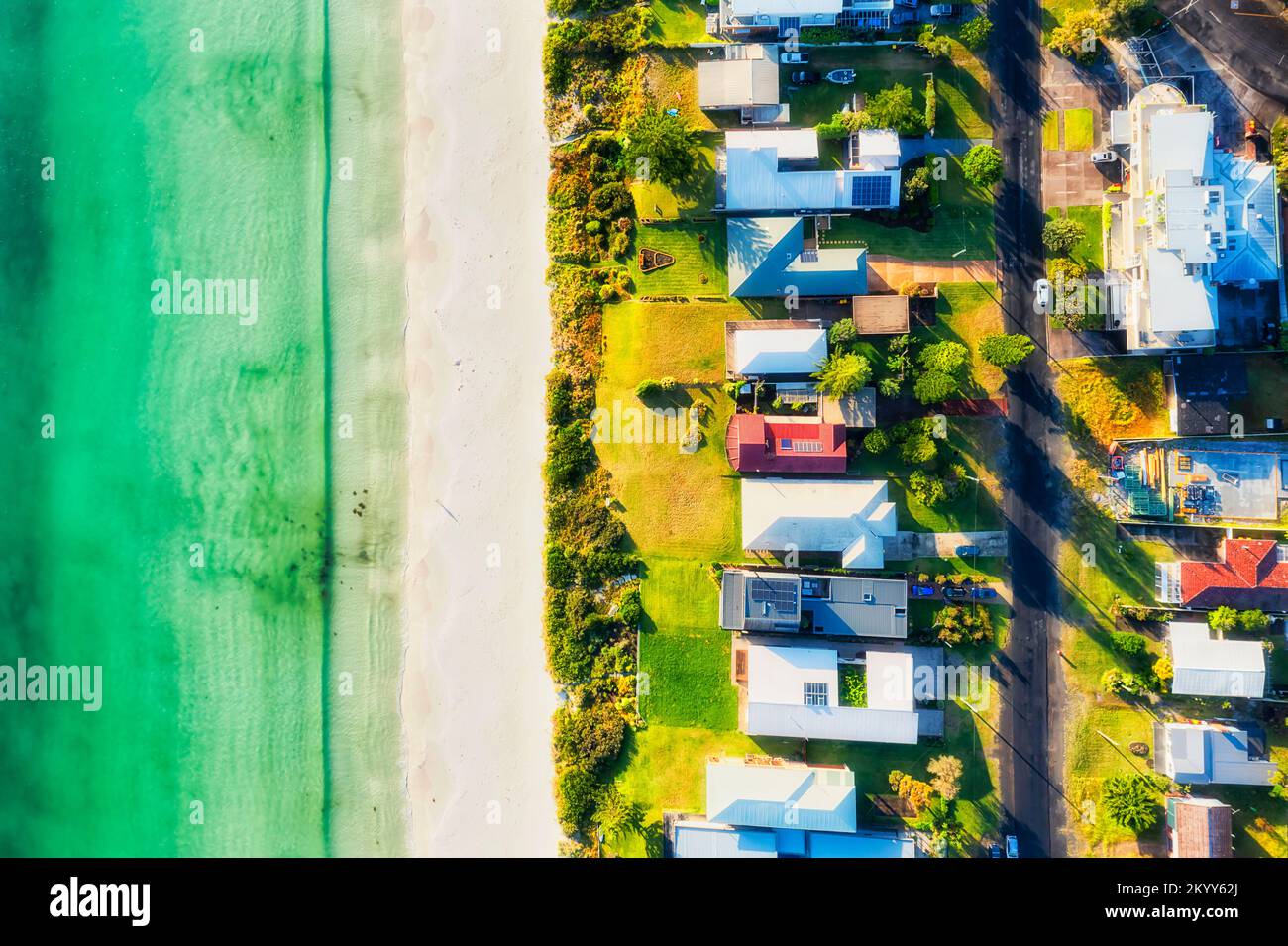 Emerald smooth waves on white sand beach in Aerial top down view over ...