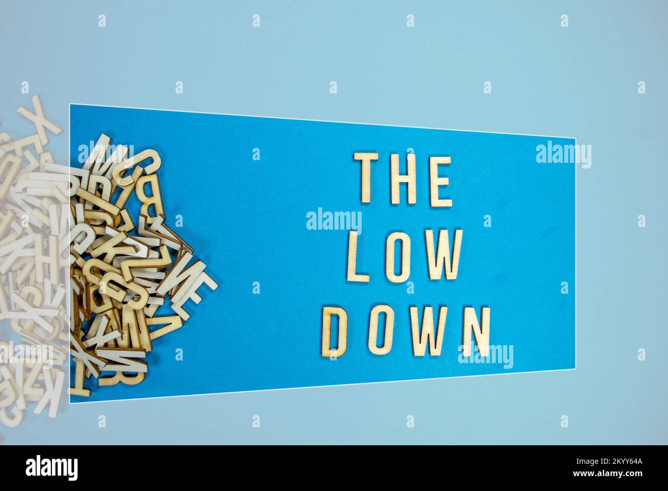 THE LOW DOWN in wooden English words language capital letters spilling ...