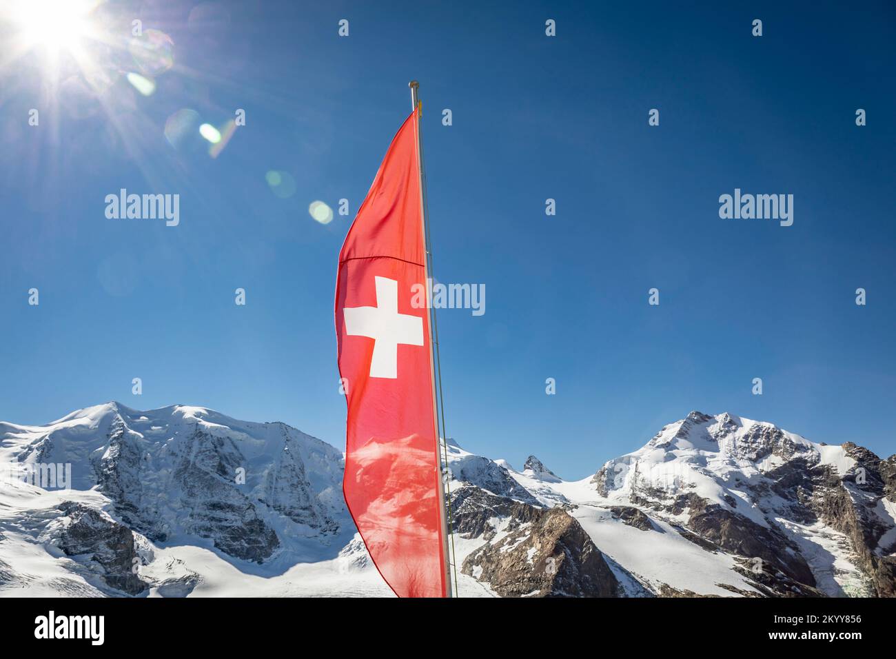 Swiss flag and Bernina mountain range with glaciers in the Alps ...