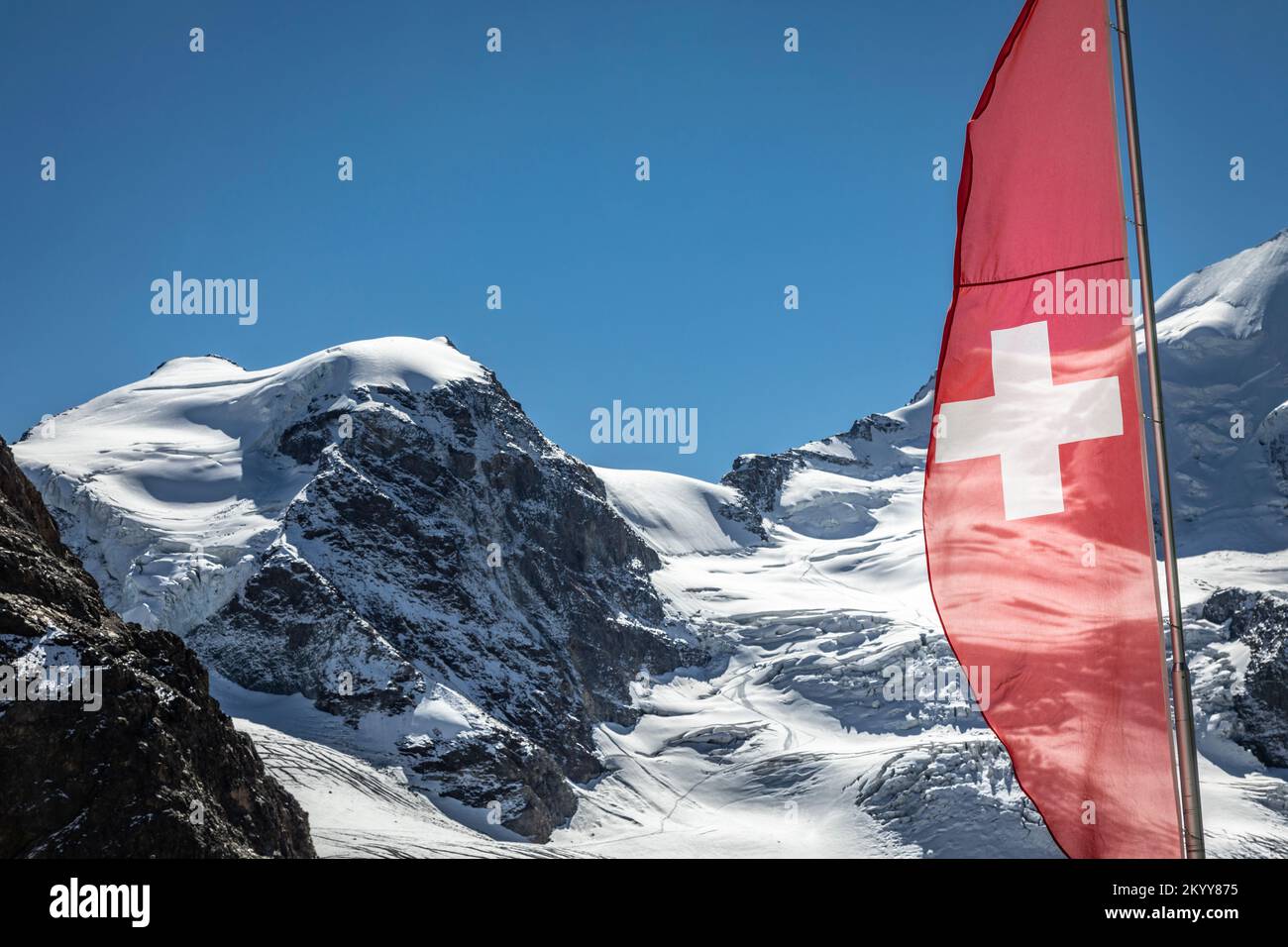 Swiss flag and Bernina mountain range with glaciers in the Alps ...