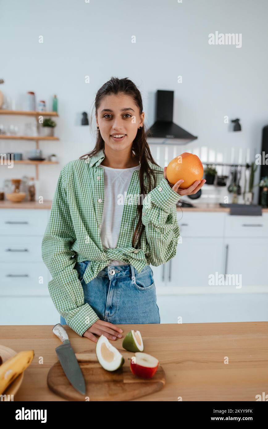 Happy healthy woman making breakfast in a kitchen Stock Photo - Alamy