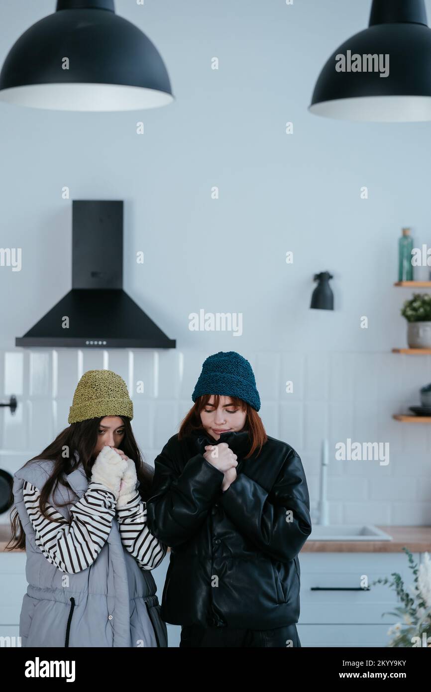 Warmly dressed women are upset with the heating turned off Stock Photo ...