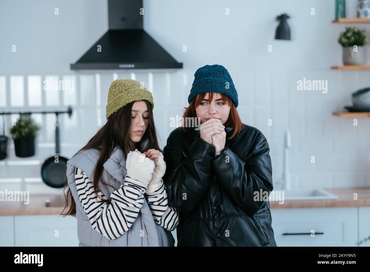 Warmly dressed women are upset with the heating turned off Stock Photo ...