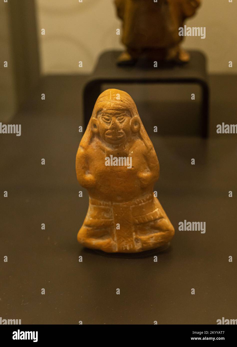 Mayan ceramic figure depicting a sitting woman wearing ear flares and ...