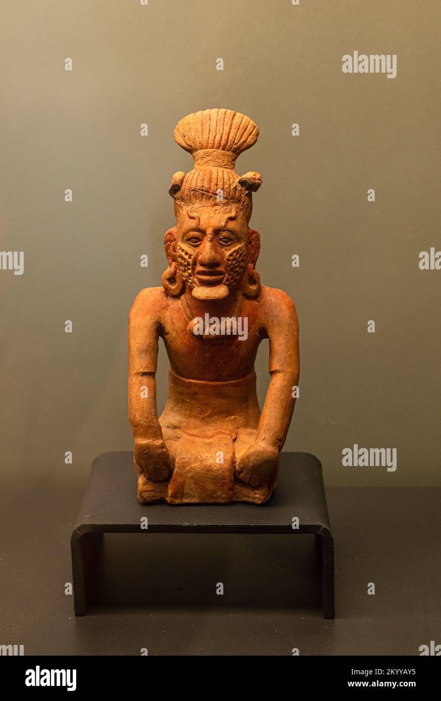 Maya effigy of a sitting man depicting scarifications and traditional ...