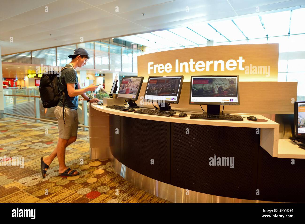 SINGAPORE - NOVEMBER 04, 2015: man use computer in Changi Airport ...