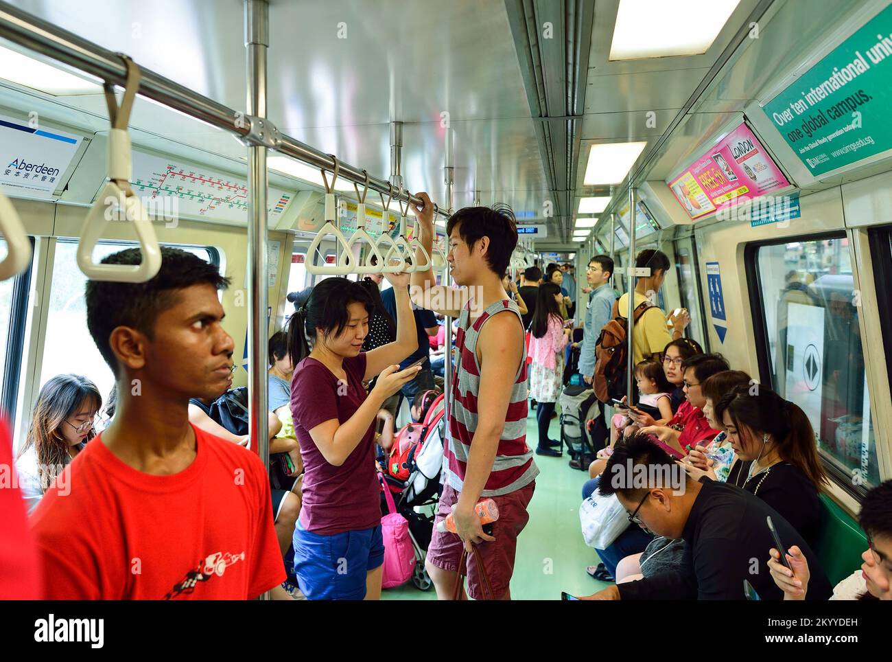 SINGAPORE - NOVEMBER 07, 2015: passengers in MRT train. The Mass Rapid ...