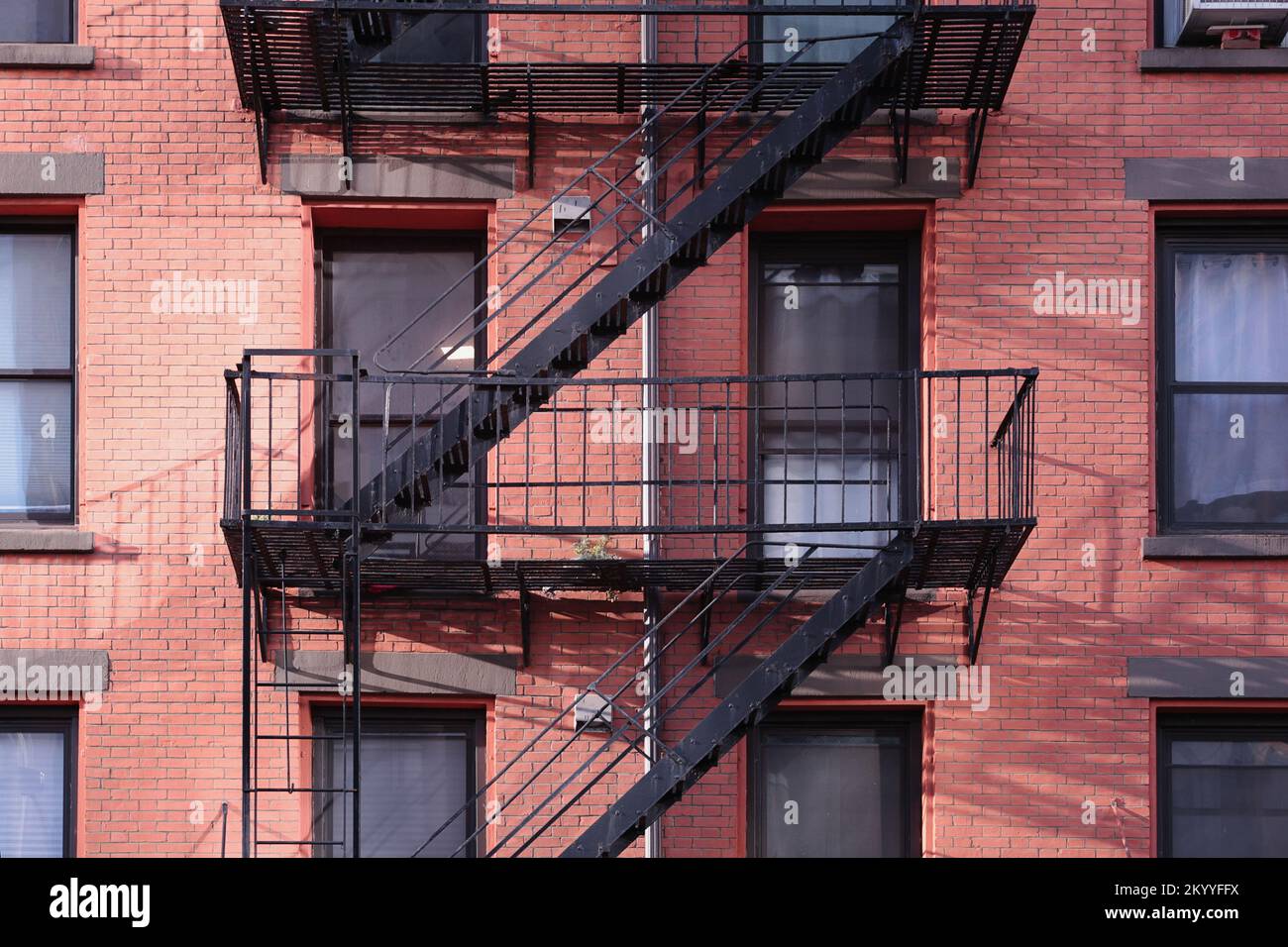 Close up New York City apartment building painted red brick exterior ...