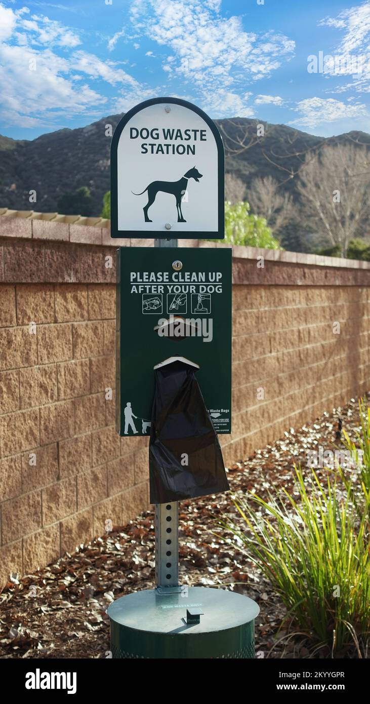 Dog waster station sign with plastic bags for waste. Clean after your ...