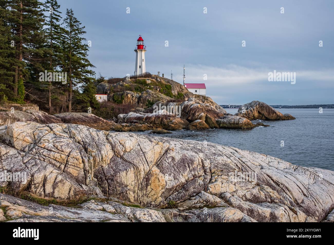 Beautiful view of a Lighthouse on a rocky coast during a cloudy sunset ...
