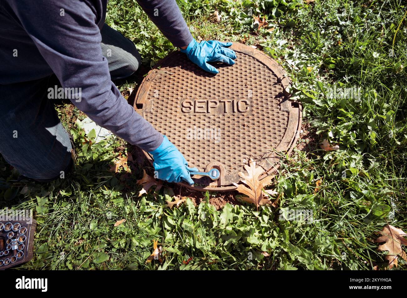A working plumber opening septic system tank. Copy space for text Stock ...