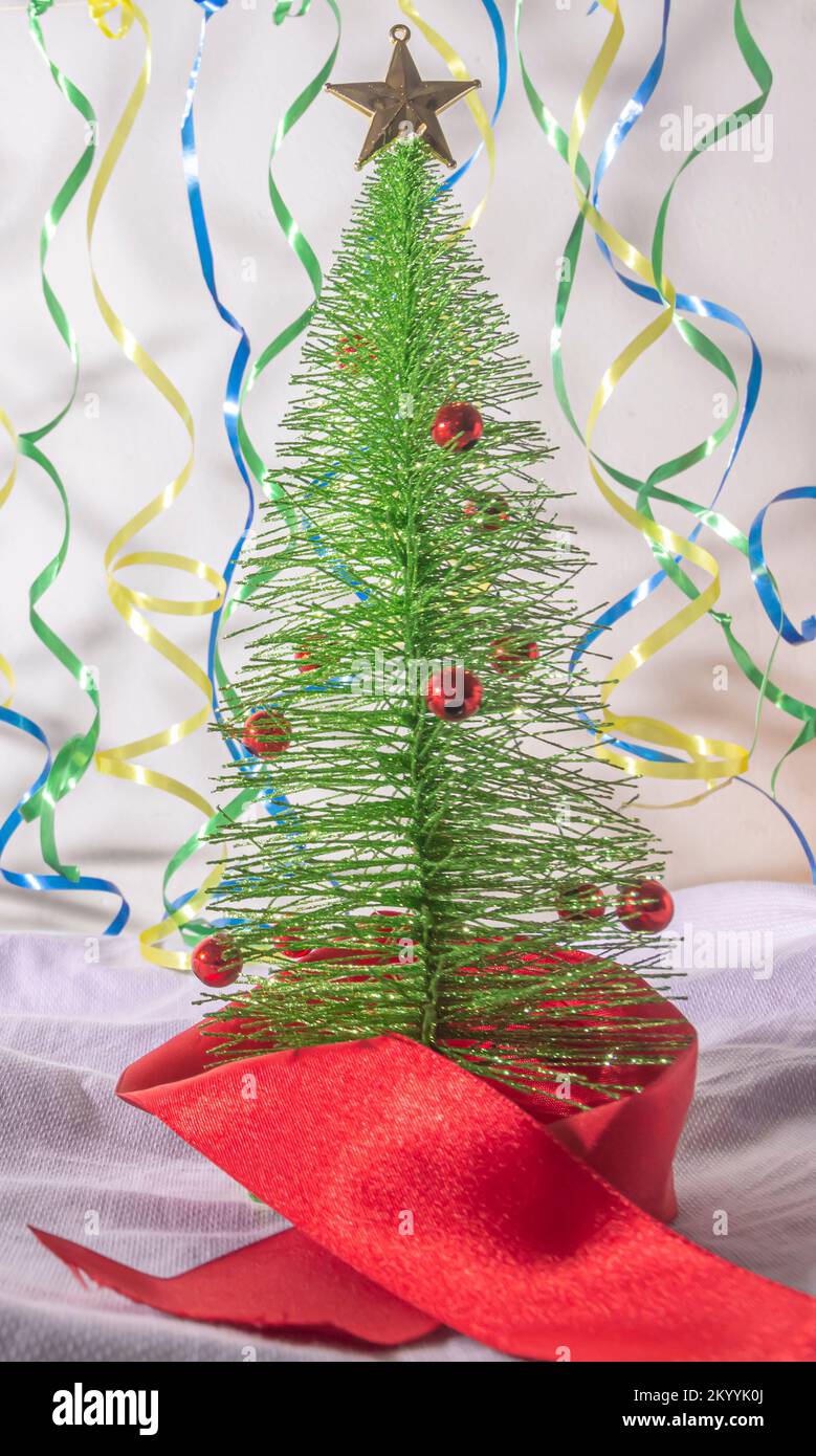 Christmas tree with a ribbon clothesline in the background with the ...