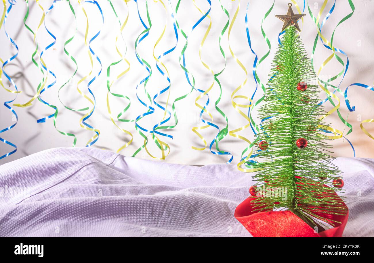 Christmas tree with a ribbon clothesline in the background with the ...
