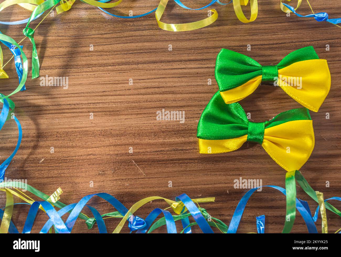 Bow tie with brazil colors on a wooden table with green, yellow and ...