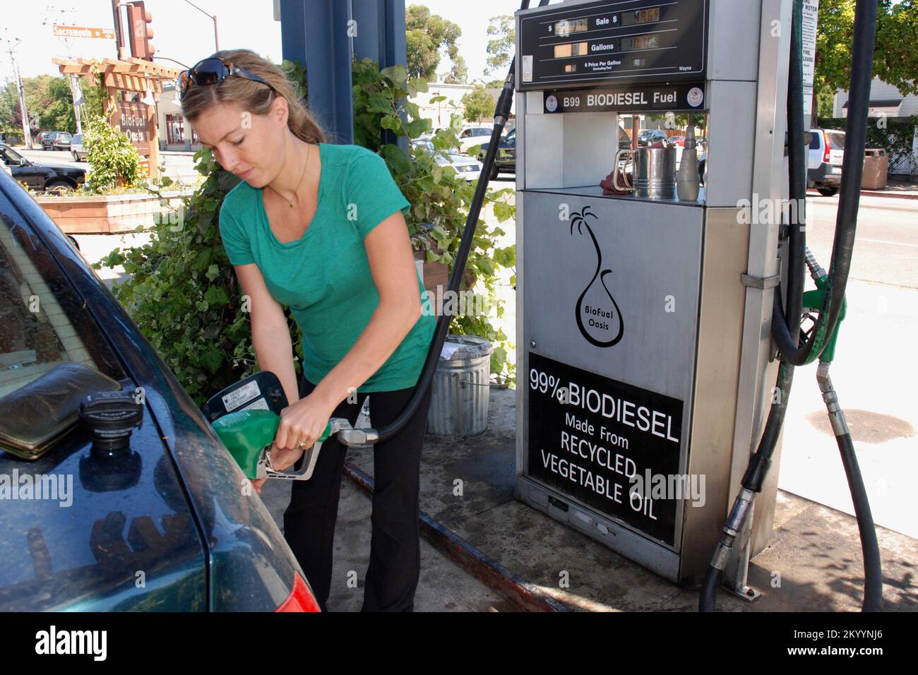 Woman filling tank at Biofuel Oasis, biodiesel station in Berkeley, CA ...