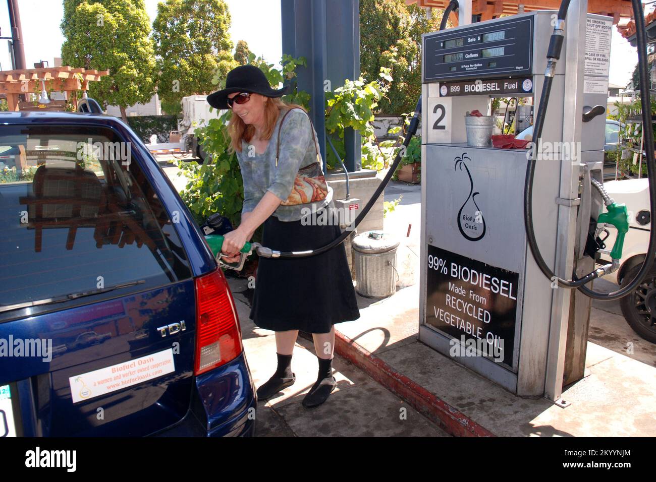 Woman filling tank at Biofuel Oasis, biodiesel station in Berkeley, CA ...