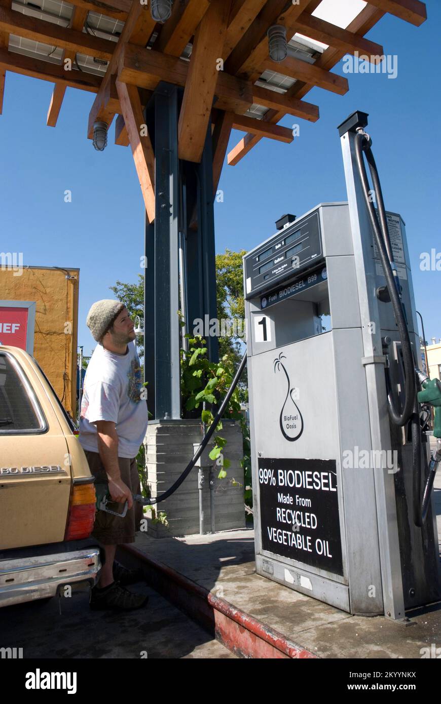 Man filling tank of Mercedes biodiesel car with biodiesel fuel at ...
