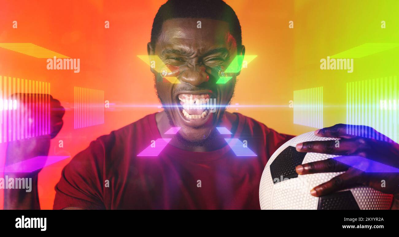 Portrait of african american male fan with ball screaming and shaking ...
