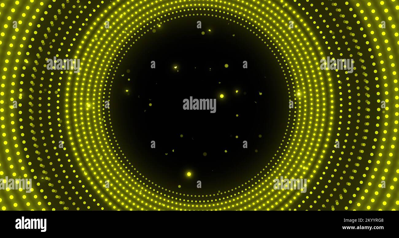Image of glowing yellow spots in circular movement on black background ...