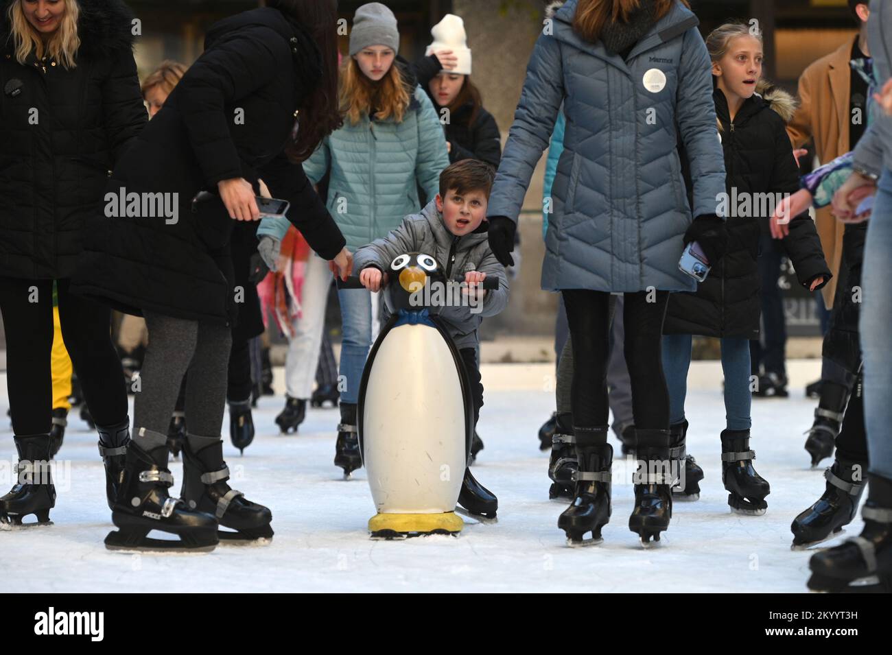New York, USA. 02nd Dec, 2022. A young skater holds on to a penguin ...