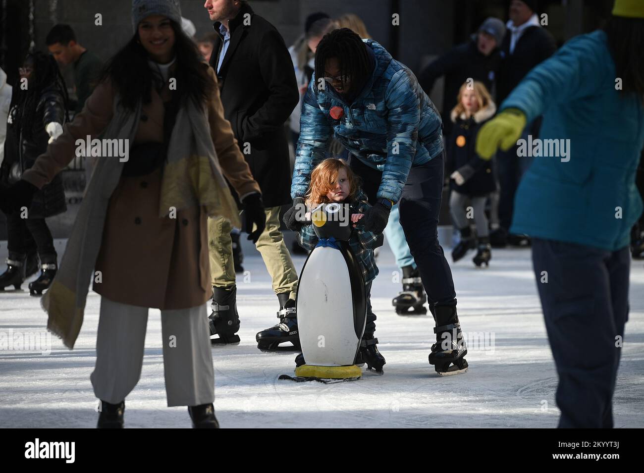 New York, USA. 02nd Dec, 2022. A young skater holds on to a penguin ...
