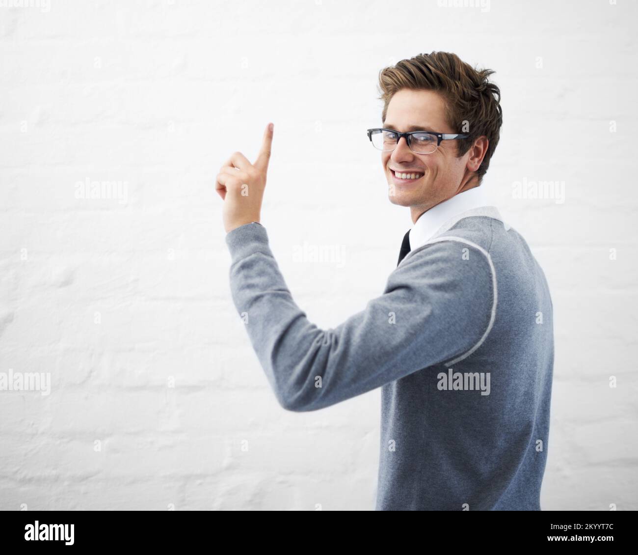 Technology at his fingertip. A young nerdy guy pointing upwards Stock ...