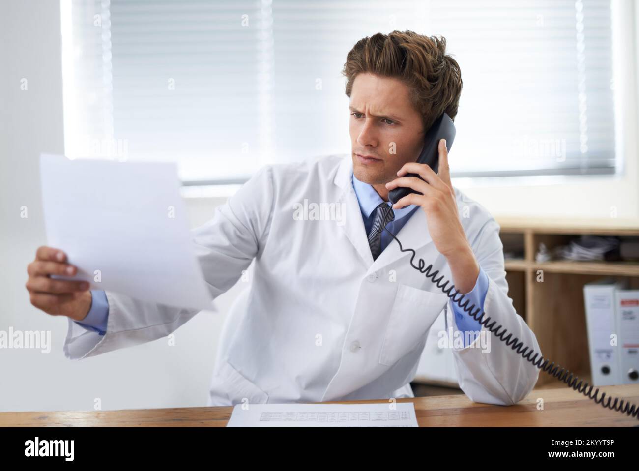 These results cant be correct. a concerned doctor sitting in his office ...
