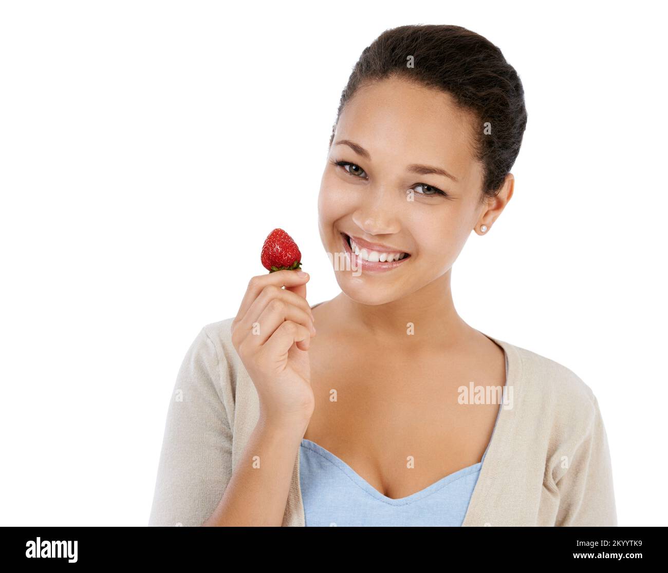 Enjoying healthy eating to the fullest. Young woman smiling while ...