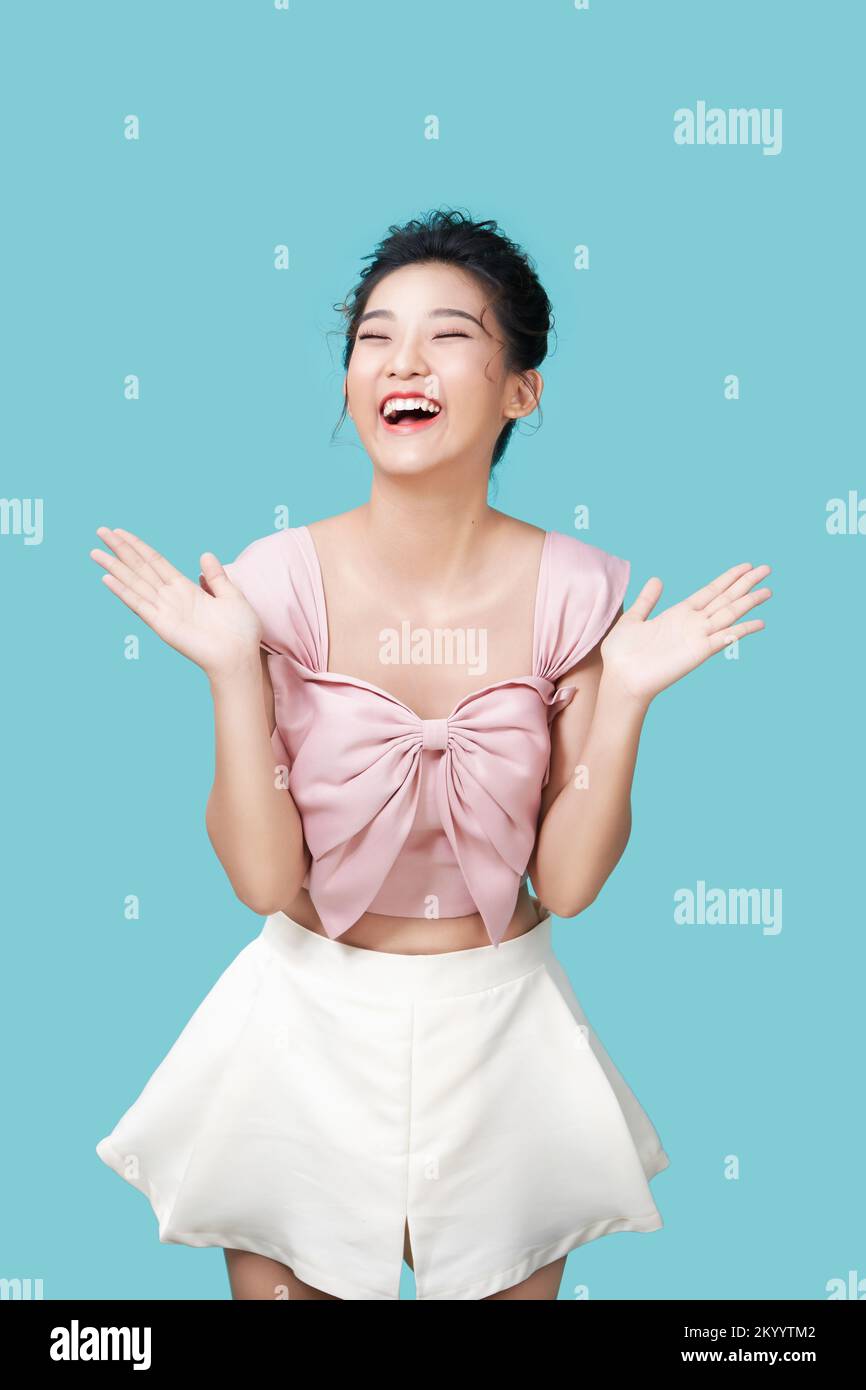 Portrait of an adorable woman with open palms near face having fun ...