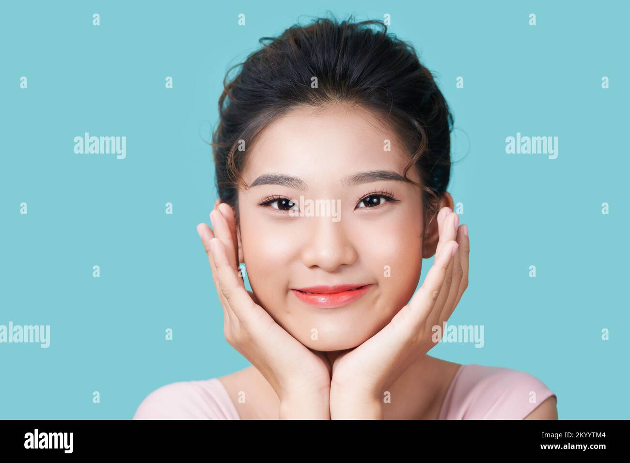 Portrait of beautiful funny woman raising palms near face and smiling ...