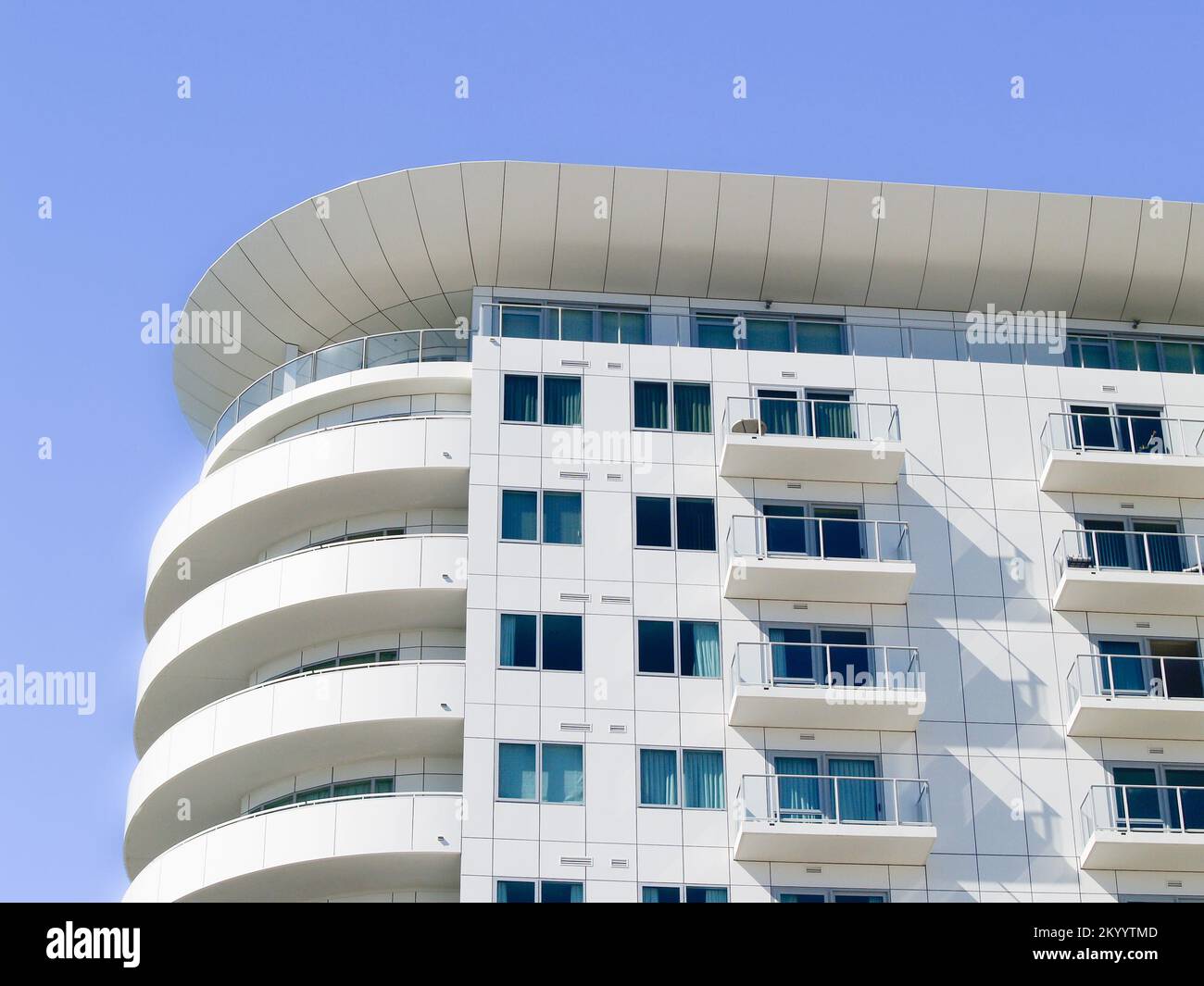 Modern white exterior of apartment building from street whit canopy and ...