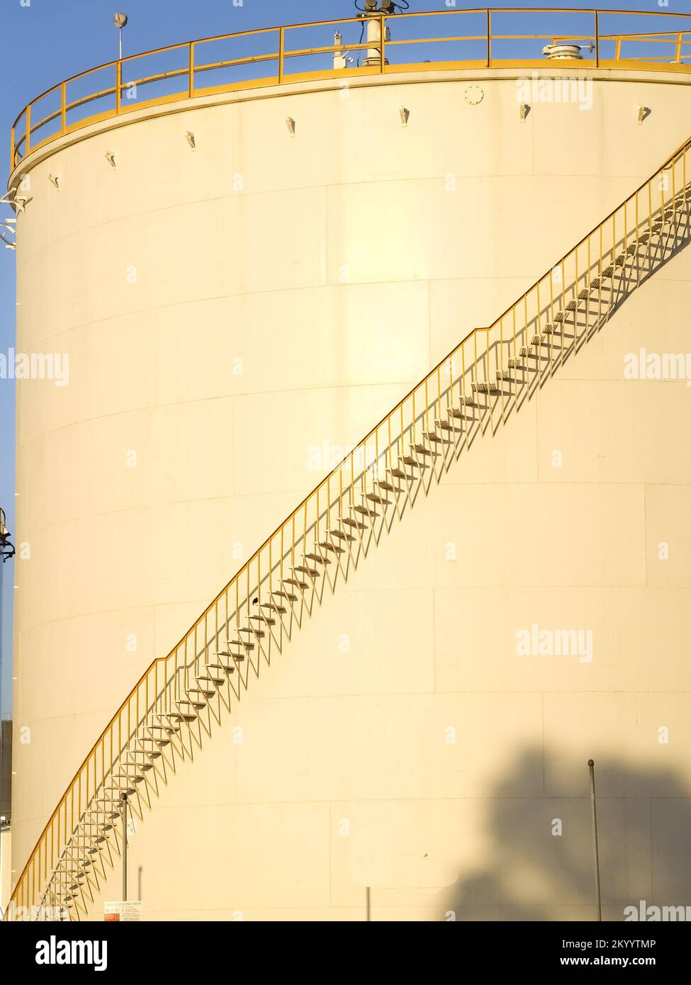 Large circular fuel storage tanks against blue sky Stock Photo - Alamy