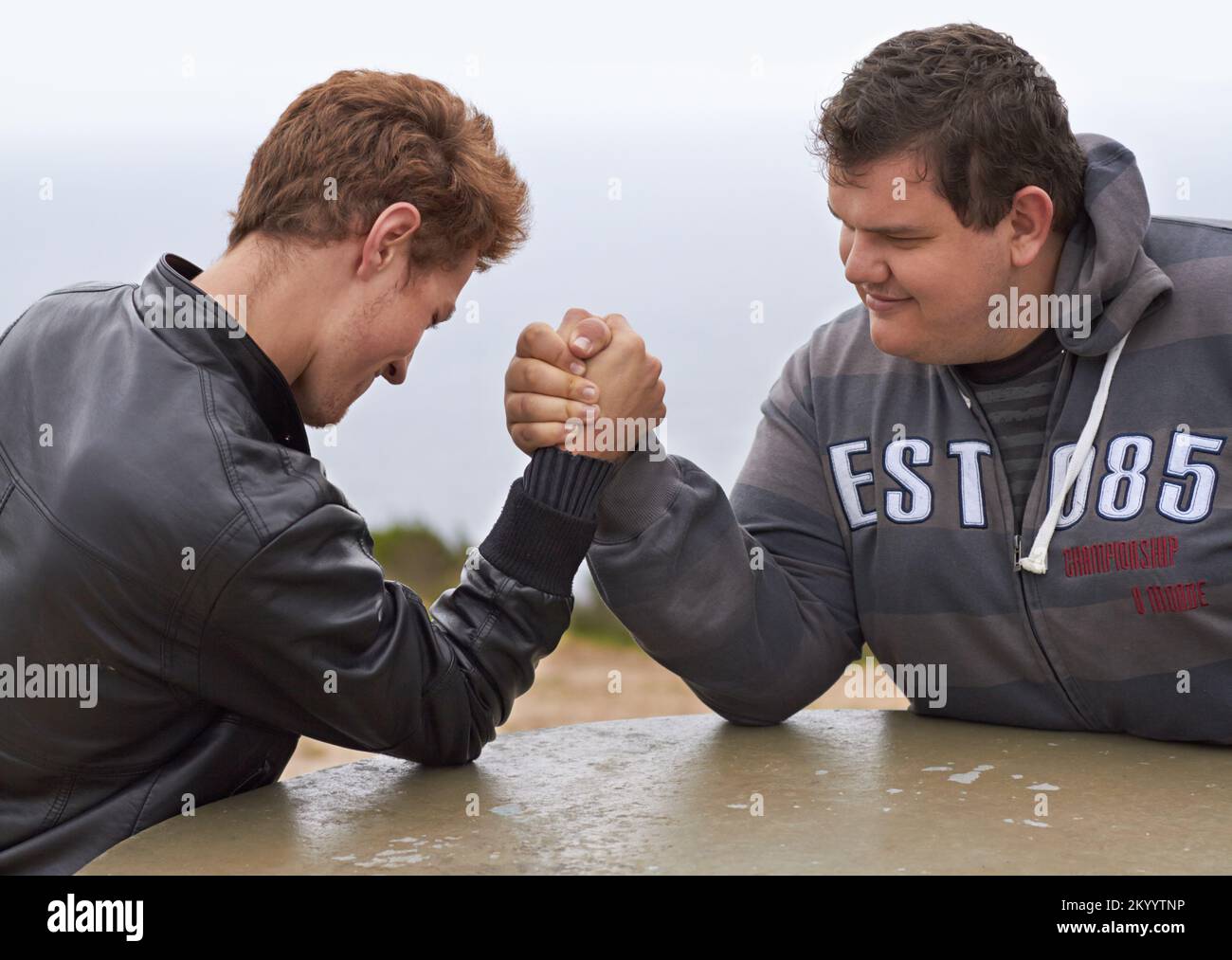 Whos the strongest. Two friends having an arm wrestling competition ...