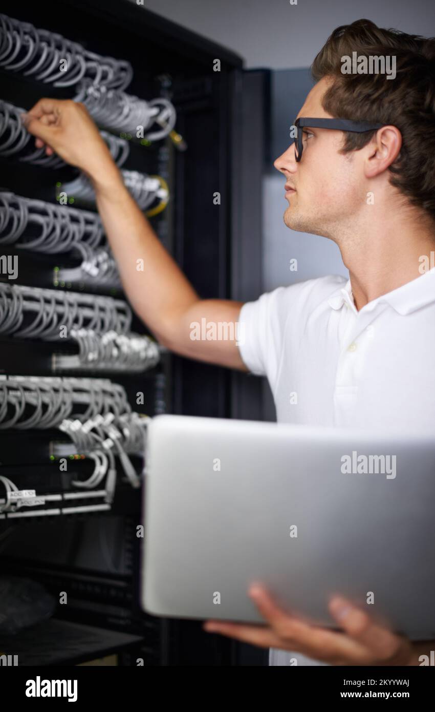 Taking care of your network needs. A computer technician fixing a ...