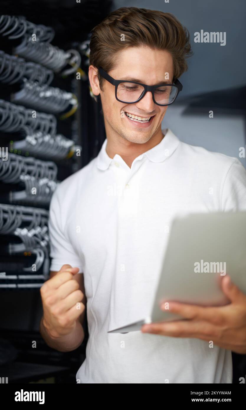 Taking care of your network needs. A technician in a server room ...