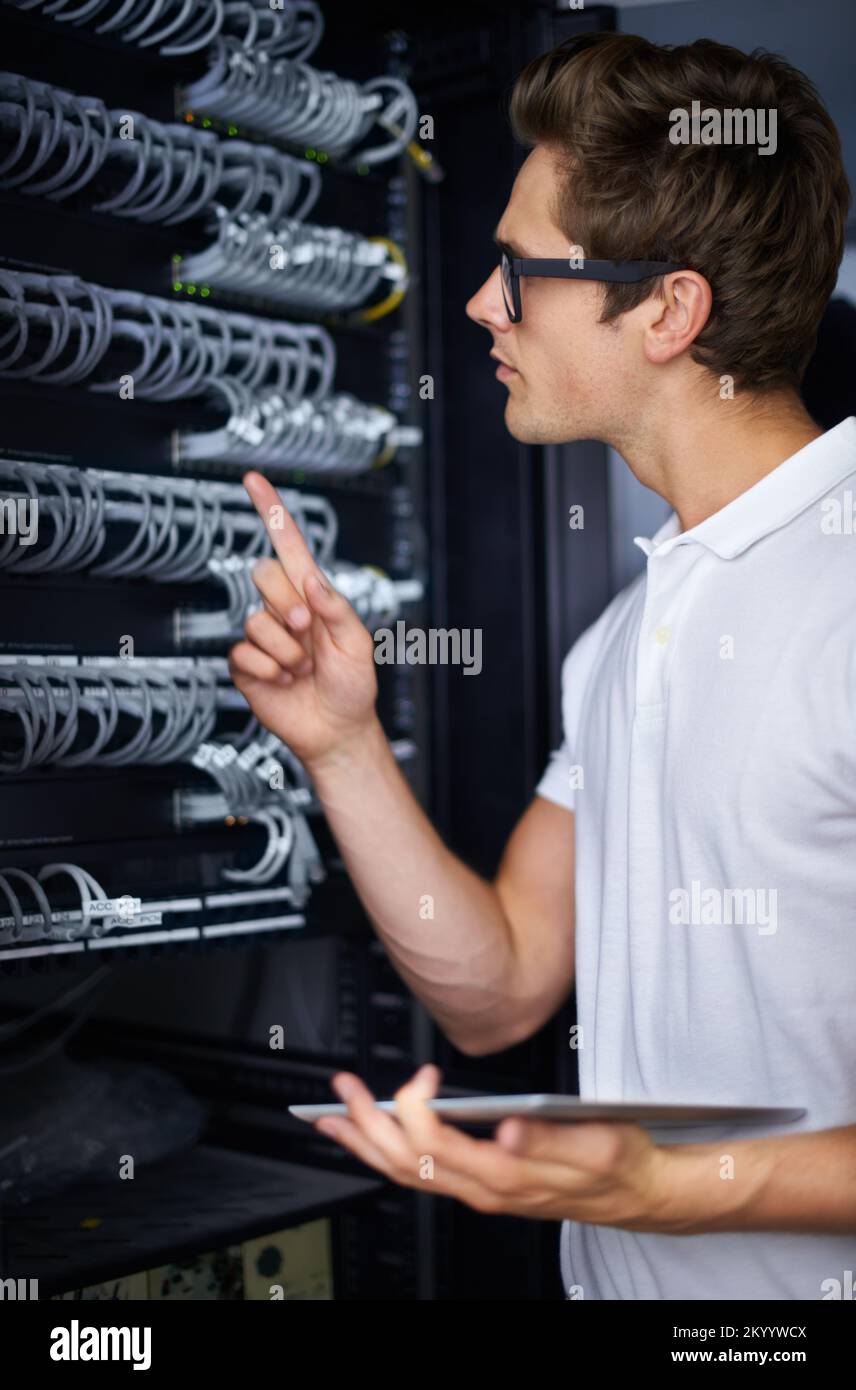 Taking care of your network needs. A computer technician fixing a ...