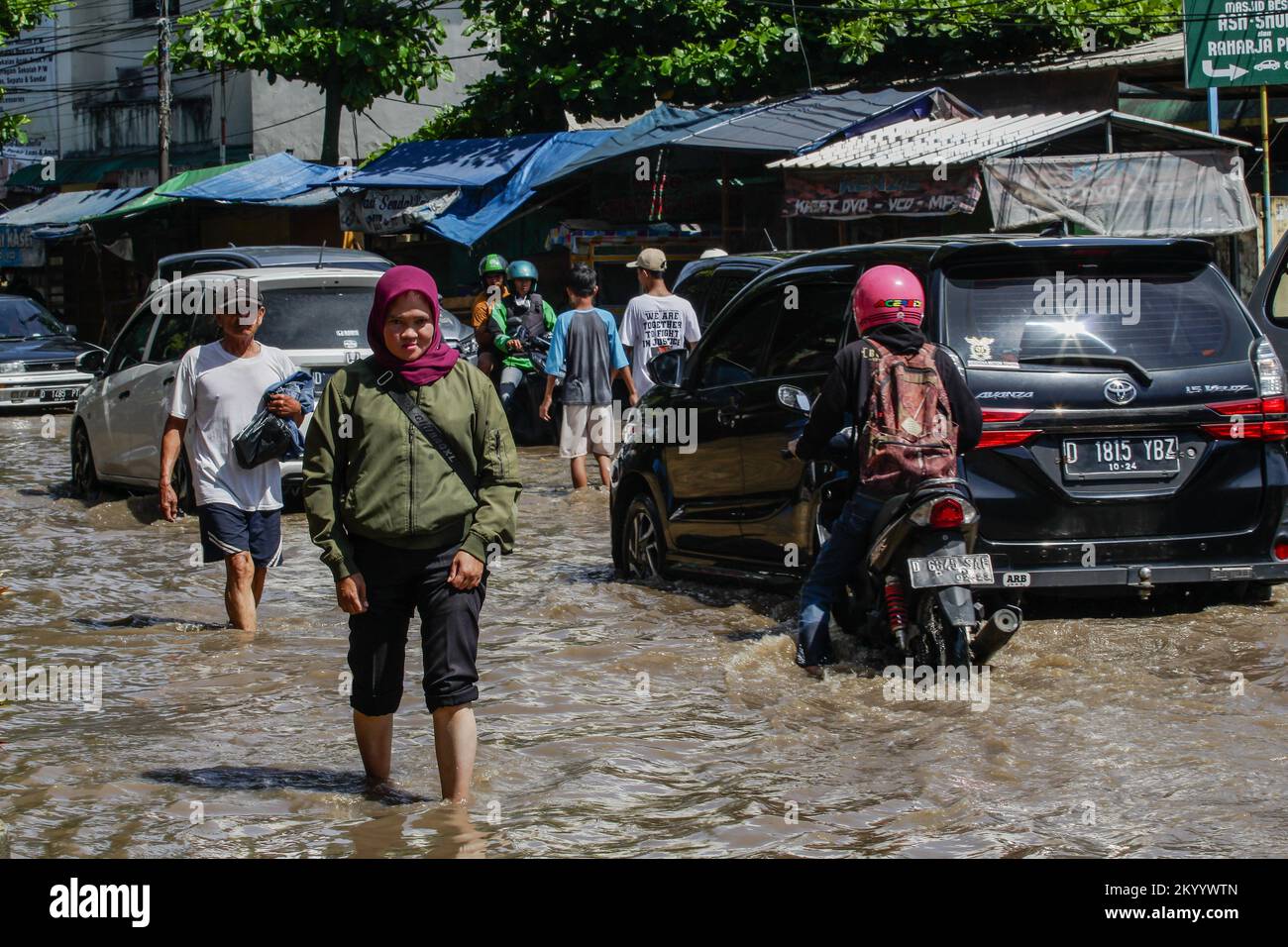 Bandung, West Java, Indonesia. 3rd Dec, 2022. A women walk passing ...