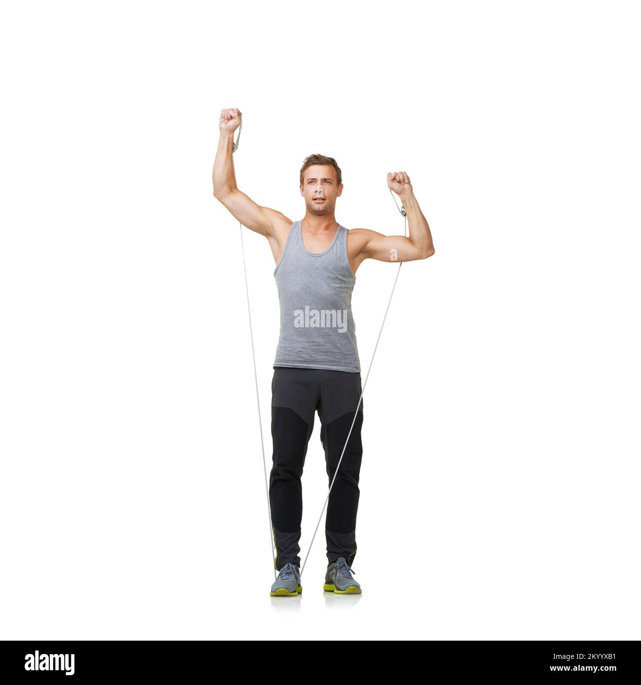 Resistance brings strength. A fit young man working out with a ...