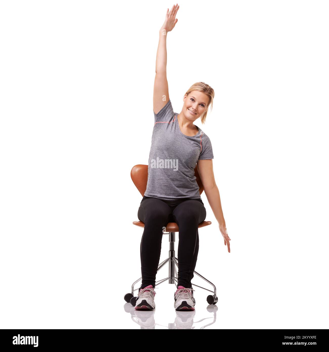 Perfect for your posture. a sporty woman doing stretches on a chair ...