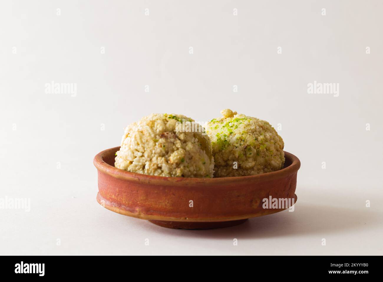 moa, popular bengali dessert is served on a clay plate. this is made of ...