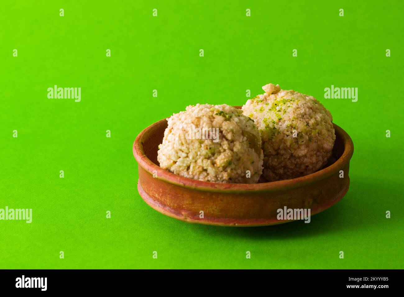 moa, popular bengali dessert is served on a clay plate. this is made of ...