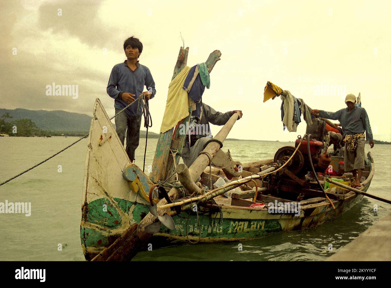 Fishermen equipped with an air compressor is getting ready for a sail ...