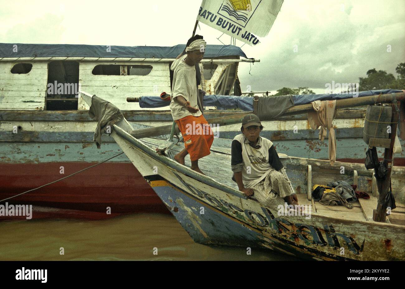 Fishermen are photographed as they are walking and sitting on a fishing ...